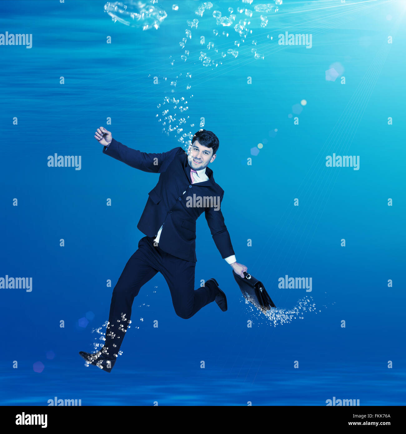 Businessman sinking in water Stock Photo - Alamy