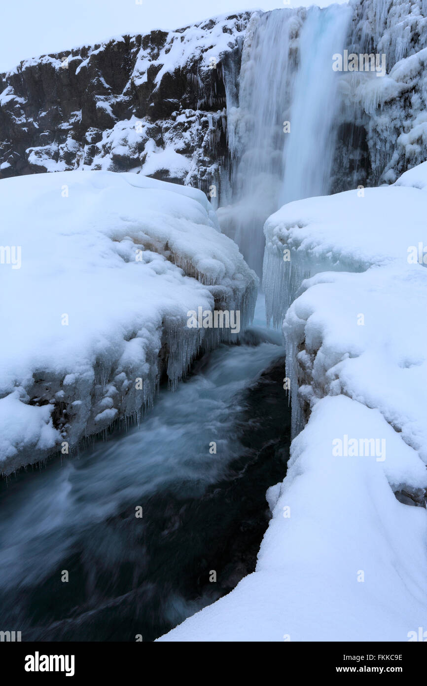 Winter snow over the Oxararfoss Waterfall, Pingvellir National Park ...
