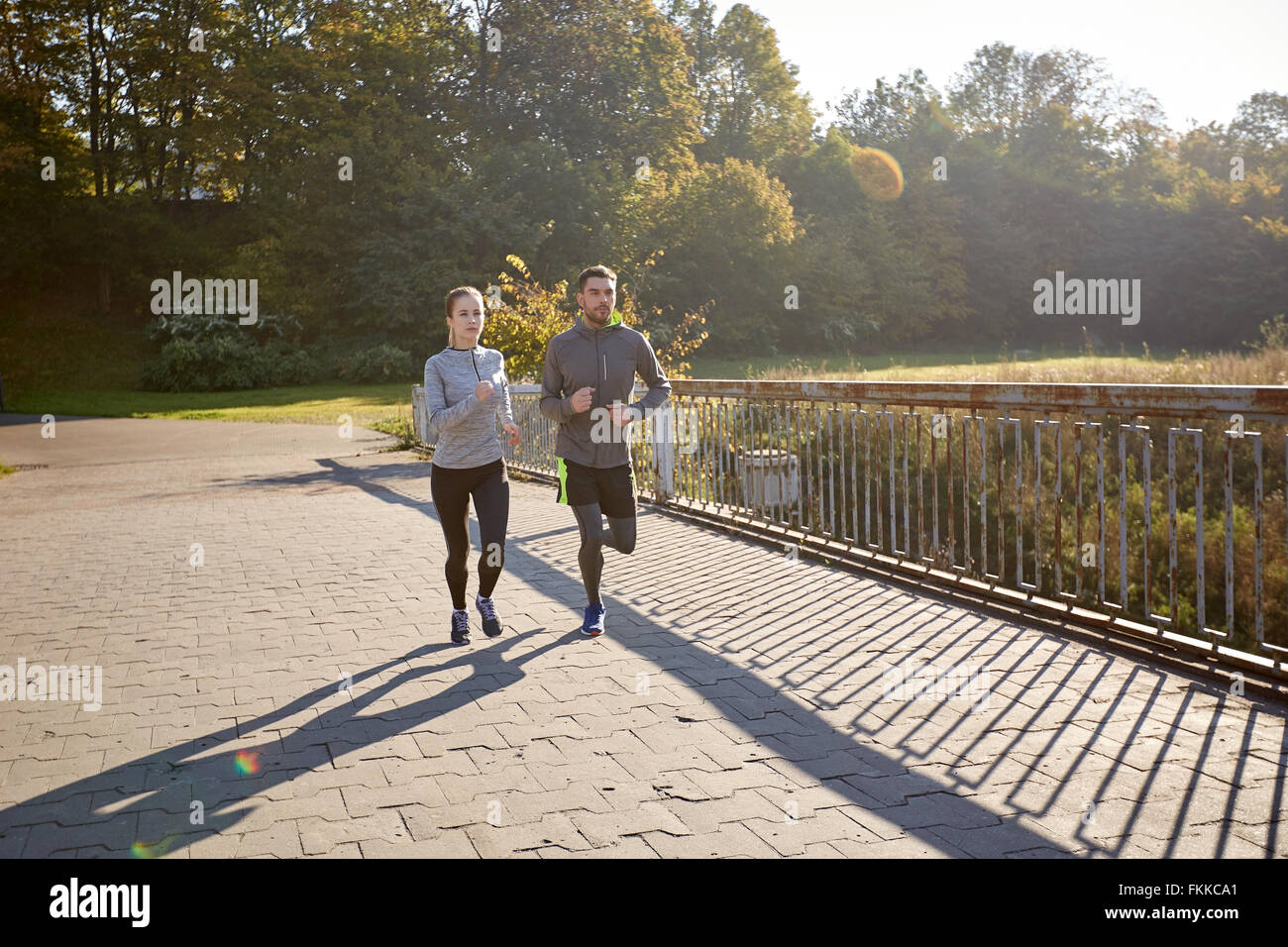 happy couple running outdoors Stock Photo - Alamy