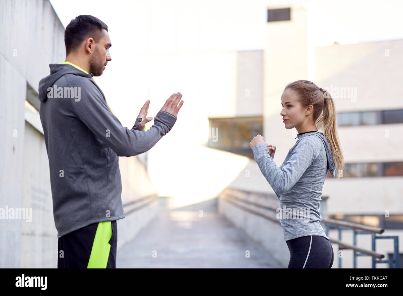 woman with coach working out strike outdoors Stock Photo - Alamy