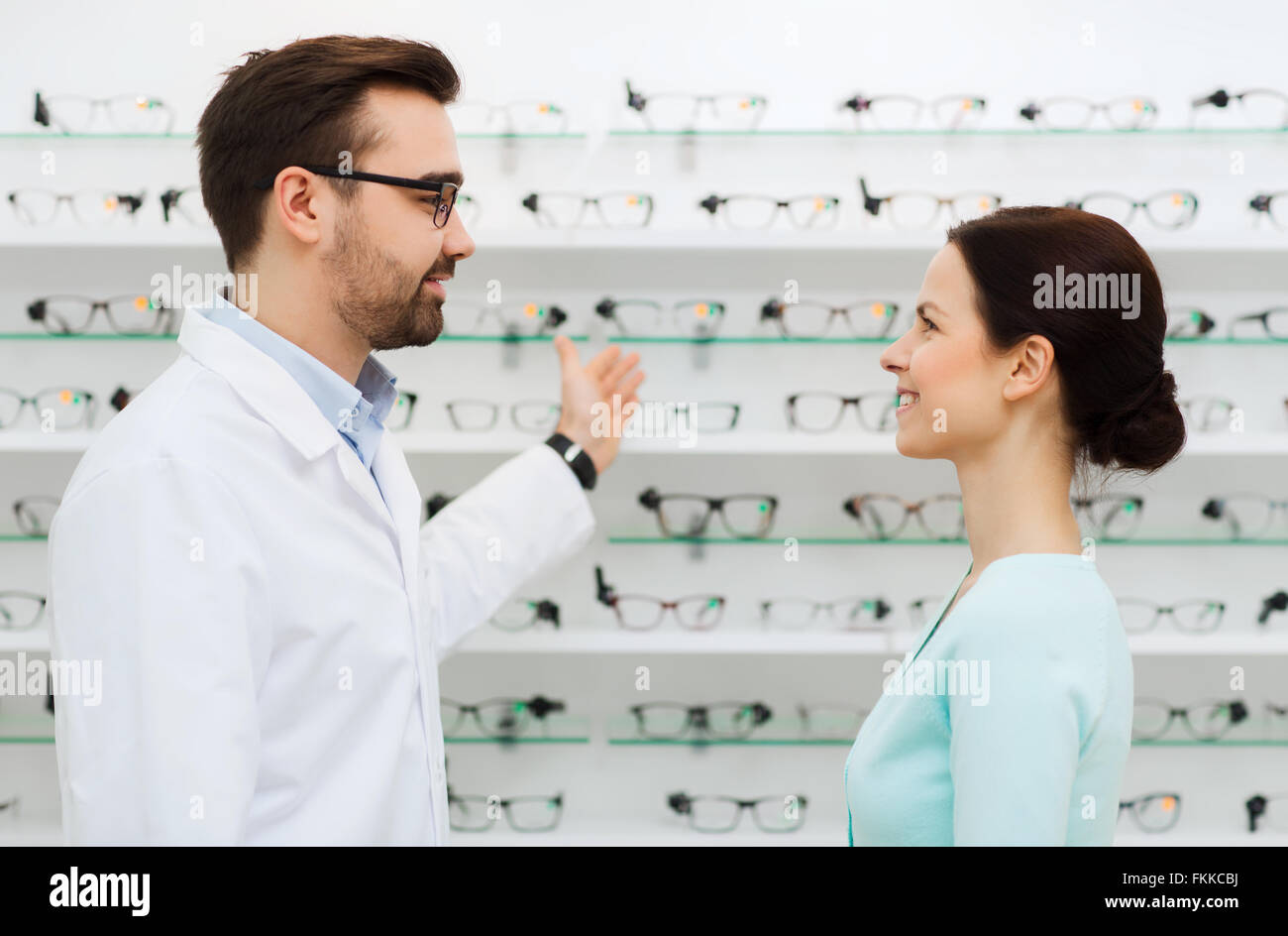 woman and optician showing glasses at optics store Stock Photo - Alamy