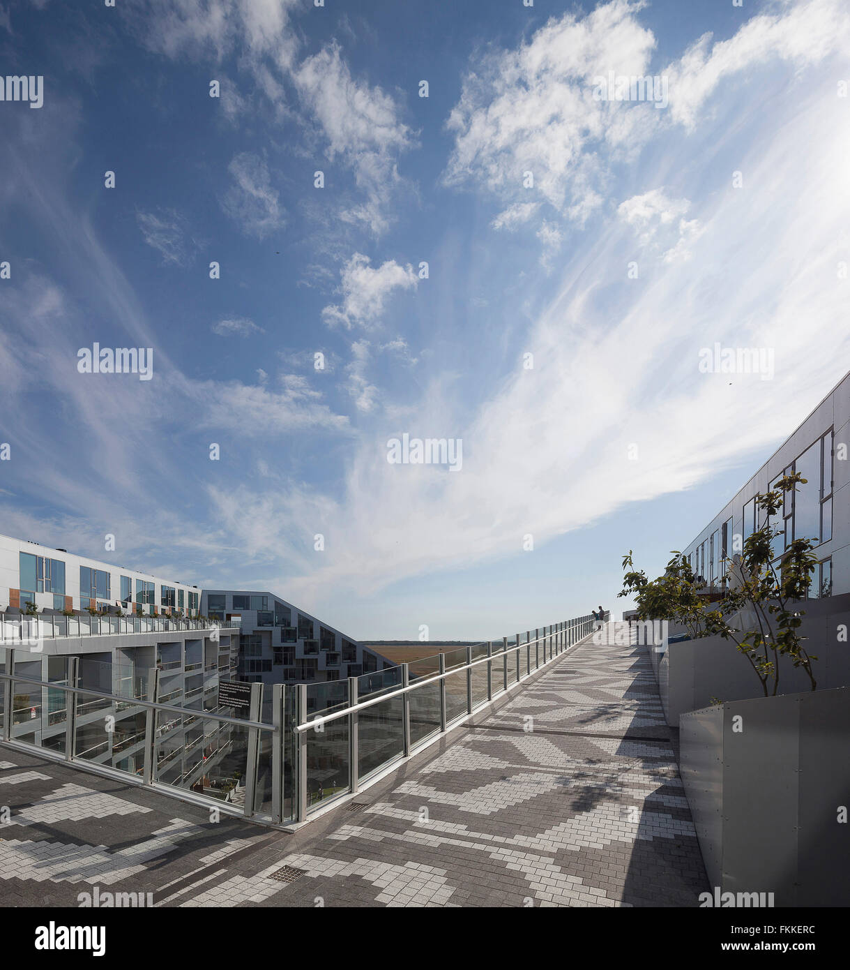 An exterior image of a modern mixed-use development in a figure of 8 in ...