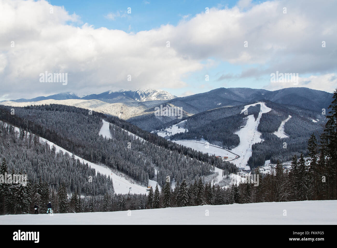 Skiers and snowboarders enjoying on slopes of ski resort Bukovel ...