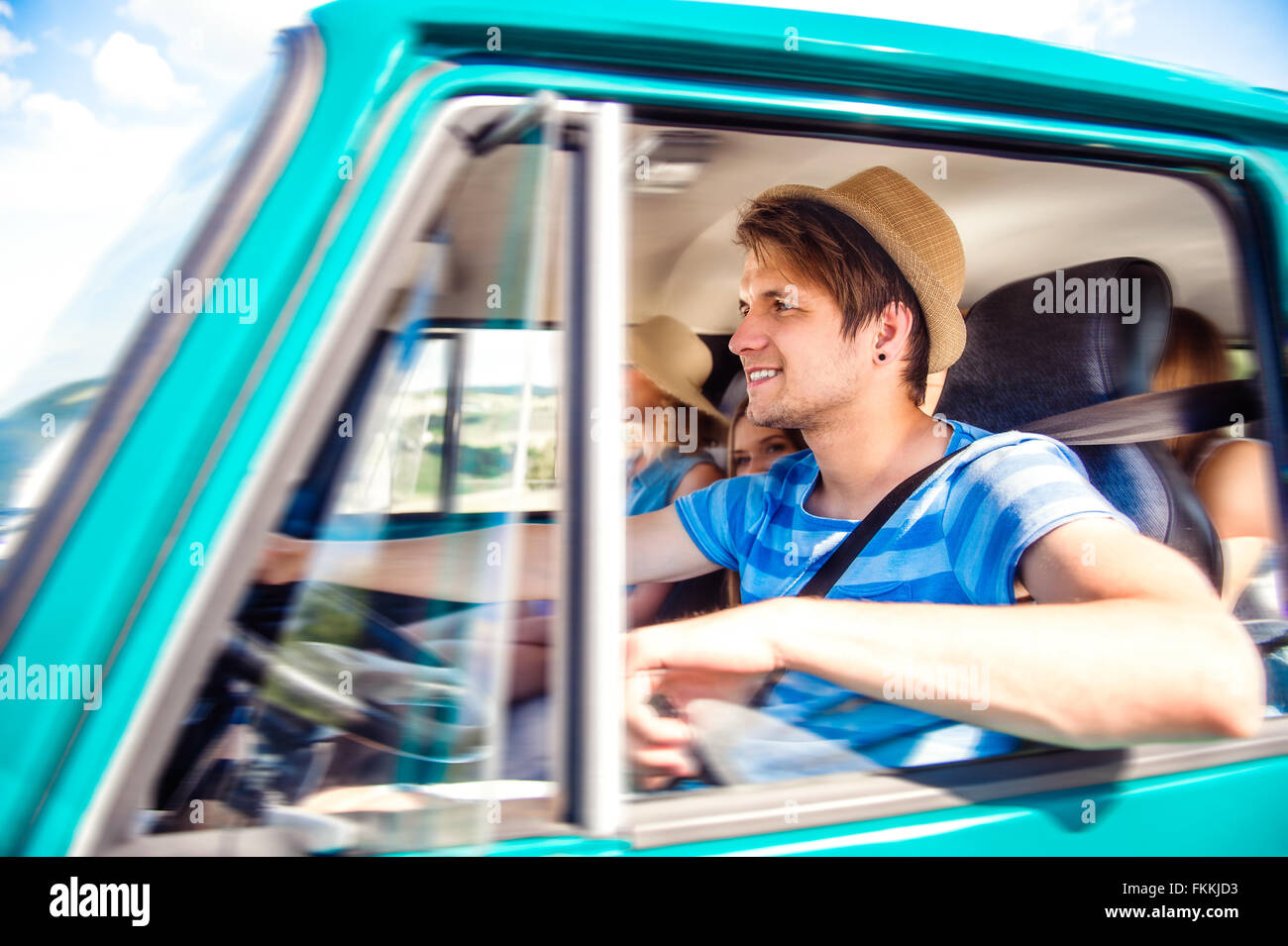 Hipster boy driving an old campervan with teenagers, roadtrip Stock ...