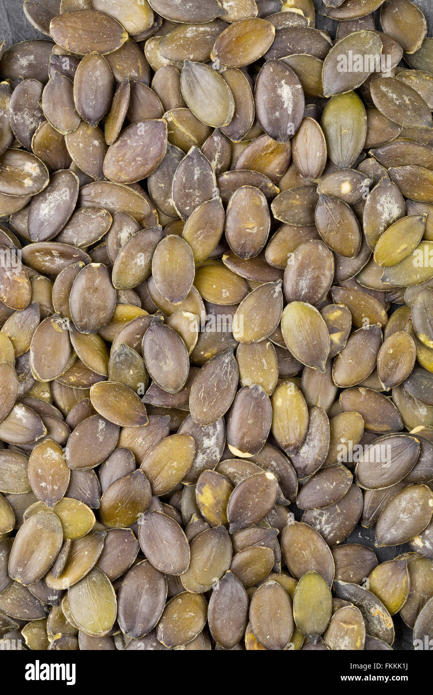Frame filling top view unshelled pumpkin seeds background Stock Photo ...