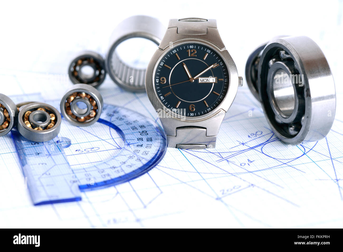 Engineering concept. Few ball bearings near ruler and wristwatch on ...