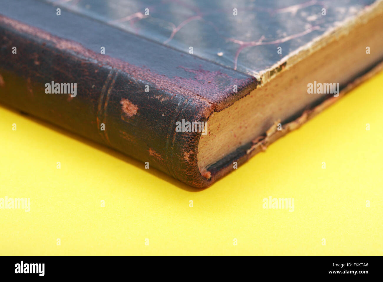 Closeup of very old book on yellow paper background Stock Photo - Alamy