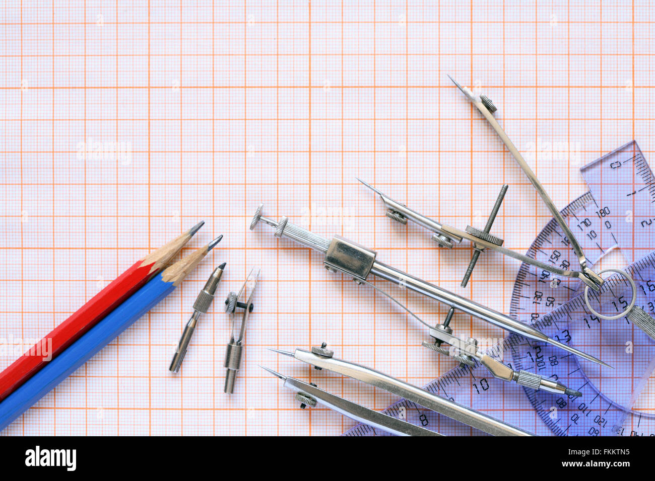 Set of drawing instrument and rulers on graph paper Stock Photo - Alamy