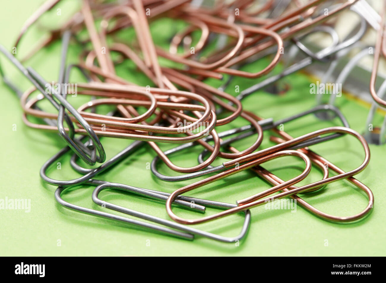 Closeup of paper clips set on open notebook with green page Stock Photo ...