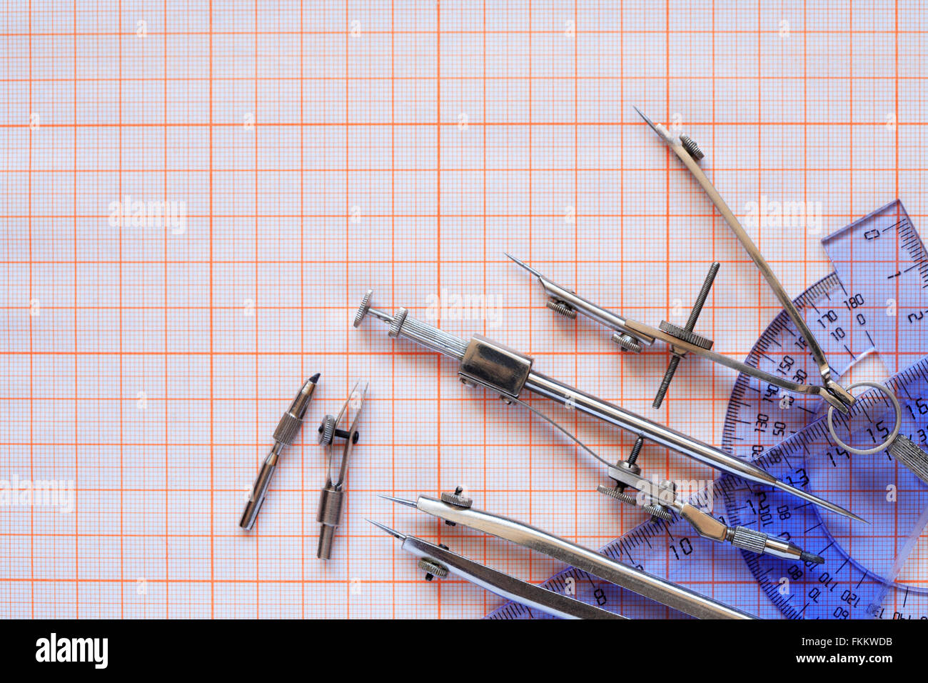 Set of drawing instrument and rulers on graph paper Stock Photo - Alamy