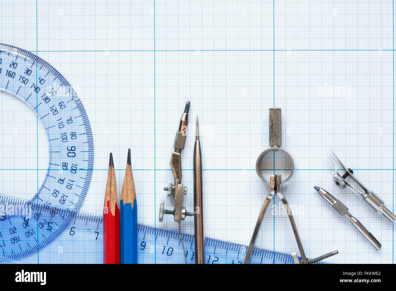 Set of drawing instrument and rulers on graph paper Stock Photo - Alamy