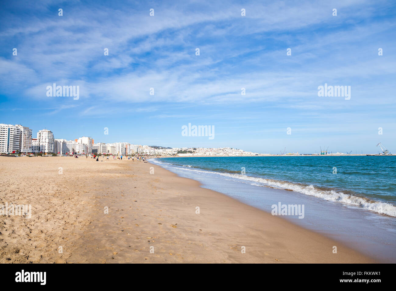 Tangier public beach with walking local people. Coastal landscape ...