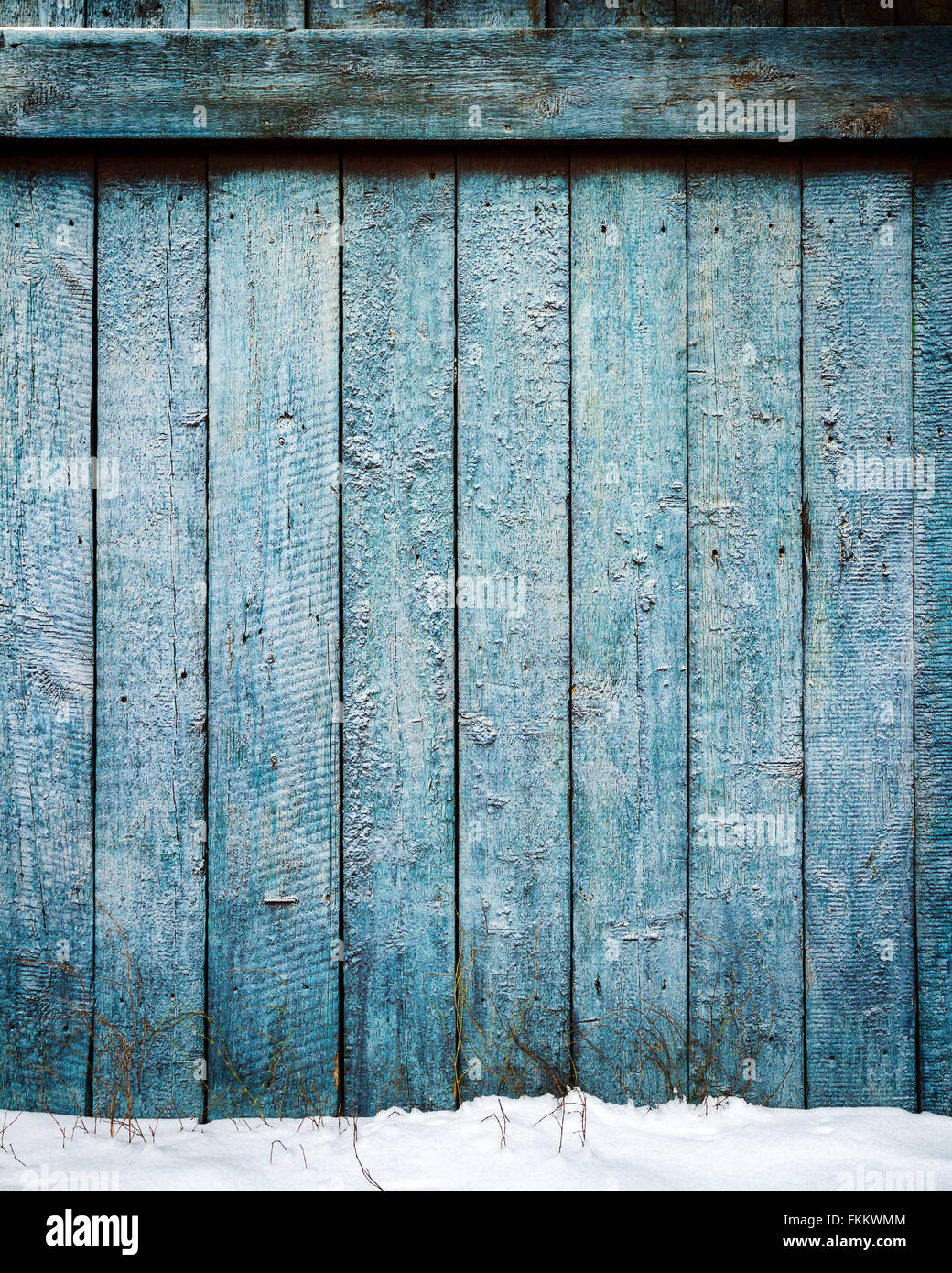 Old weathered wood plank fence and a ground covered with snow Stock ...