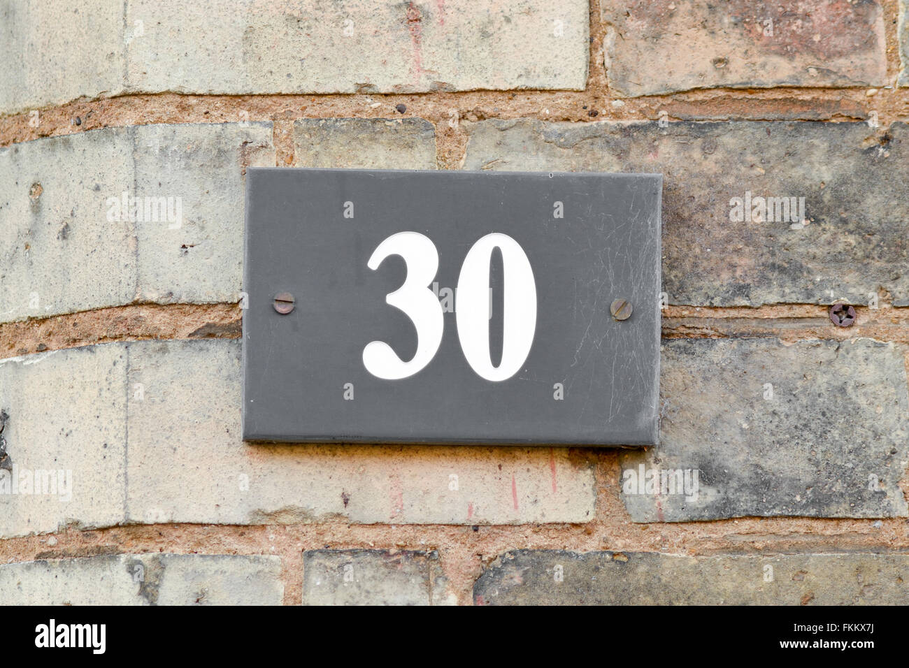 House number 30 sign in slate on wall Stock Photo - Alamy