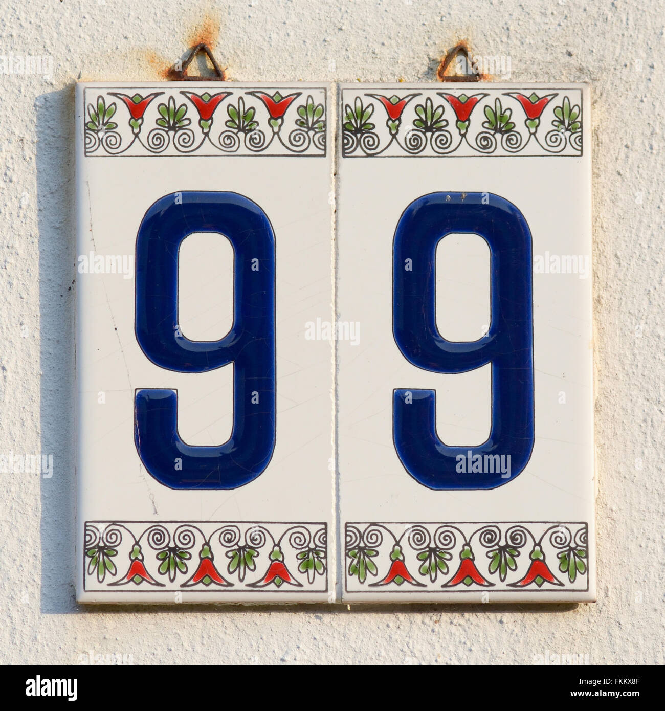 House number 99 sign on wall in ceramic tiles Stock Photo - Alamy