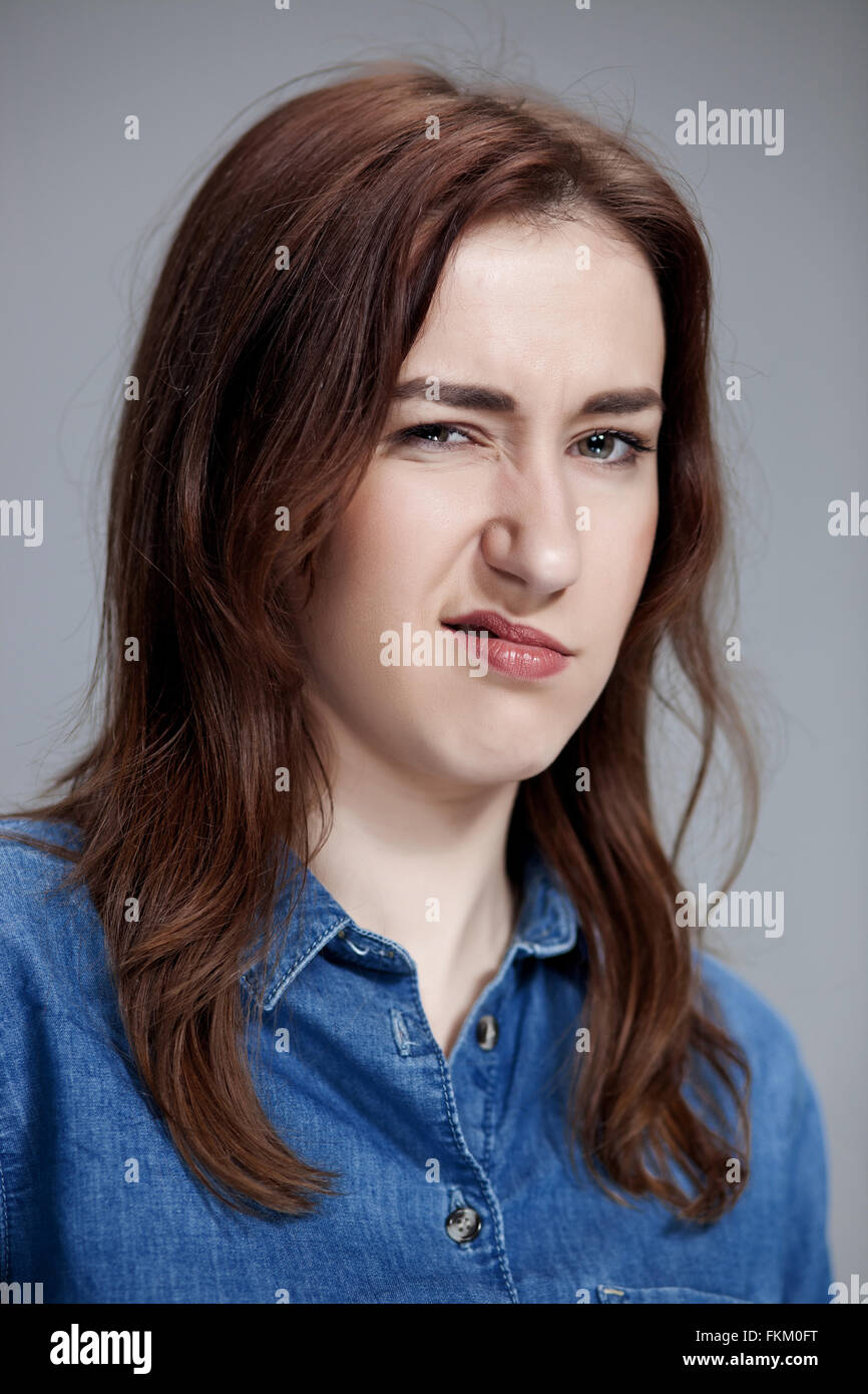 The portrait of disgusted woman on gray Stock Photo - Alamy