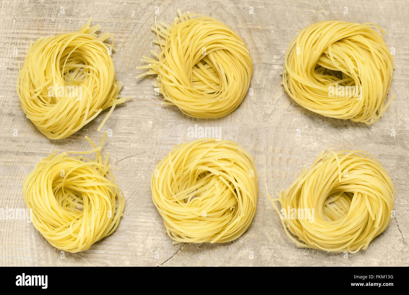 Pasta lying on a wooden surface Stock Photo - Alamy