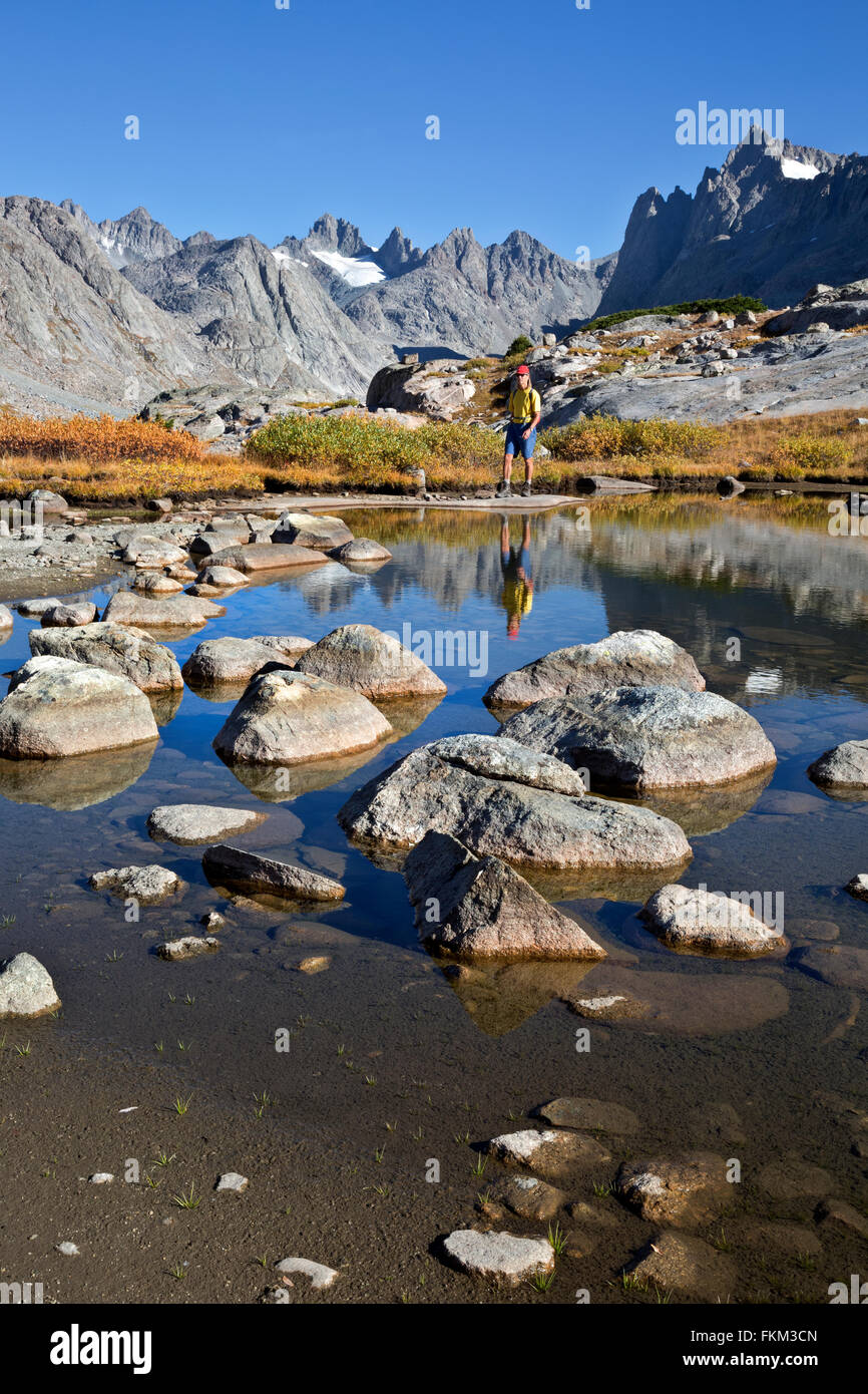 WYOMING - Hiker at a small tarn near Upper Titcomb Lake in the Titcomb ...
