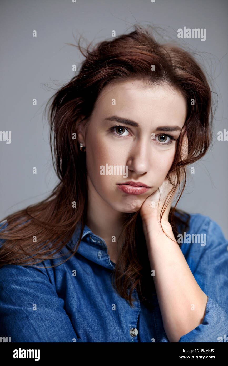 The portrait of a beautiful sad girl closeup on gray Stock Photo - Alamy