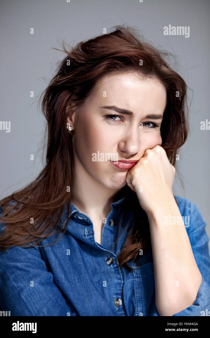 The portrait of a beautiful sad girl closeup on gray Stock Photo - Alamy