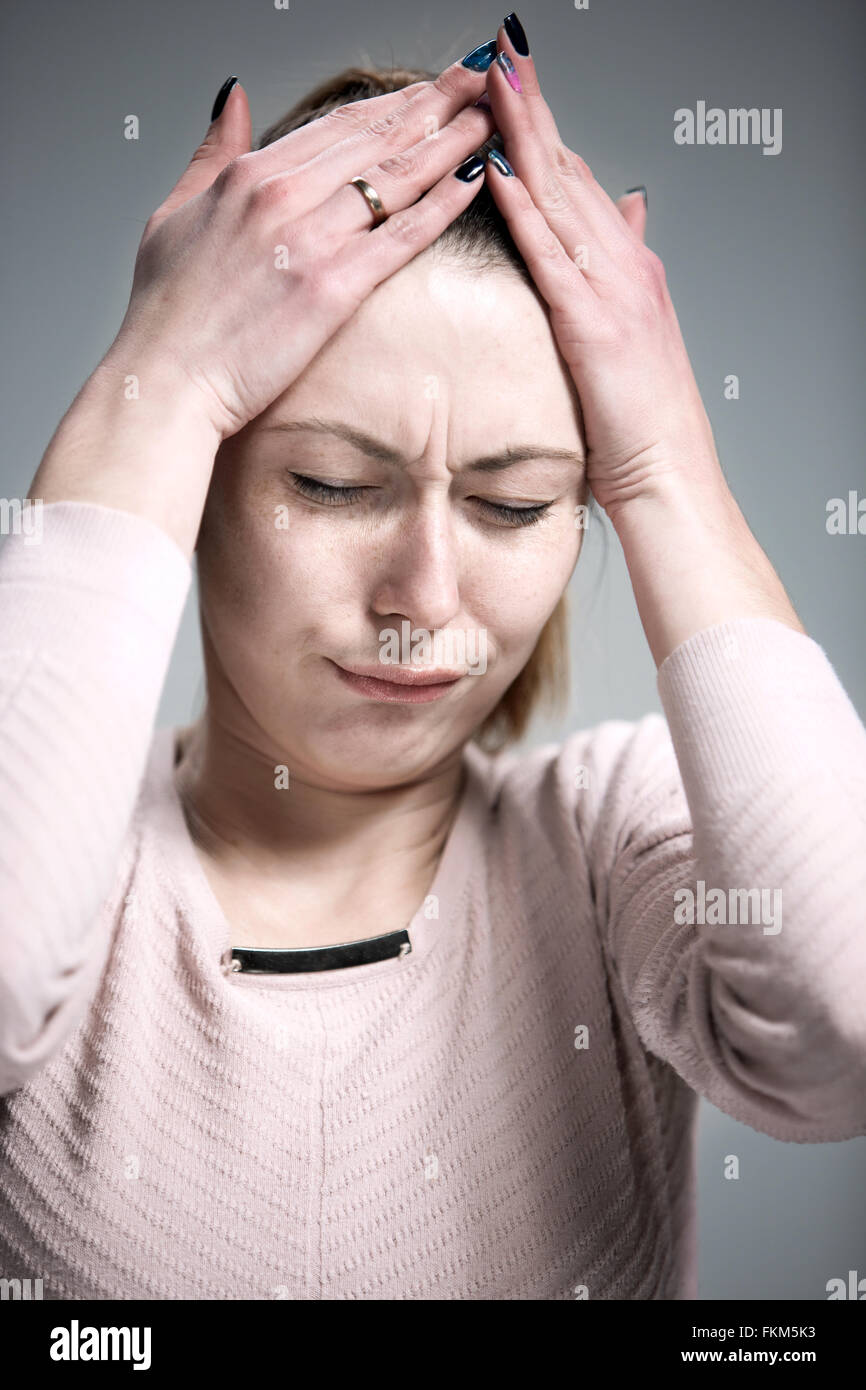 The portrait of a beautiful sad girl closeup on gray Stock Photo - Alamy