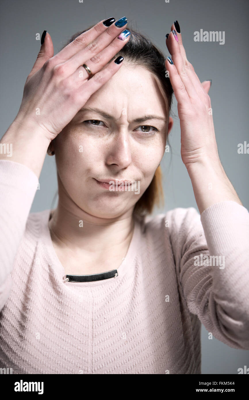 The Portrait Of A Beautiful Sad Girl Closeup On Gray Stock Photo Alamy