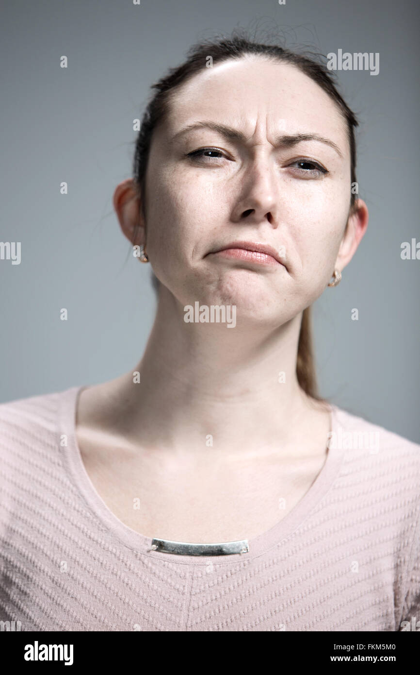 The portrait of disgusted woman on gray Stock Photo - Alamy