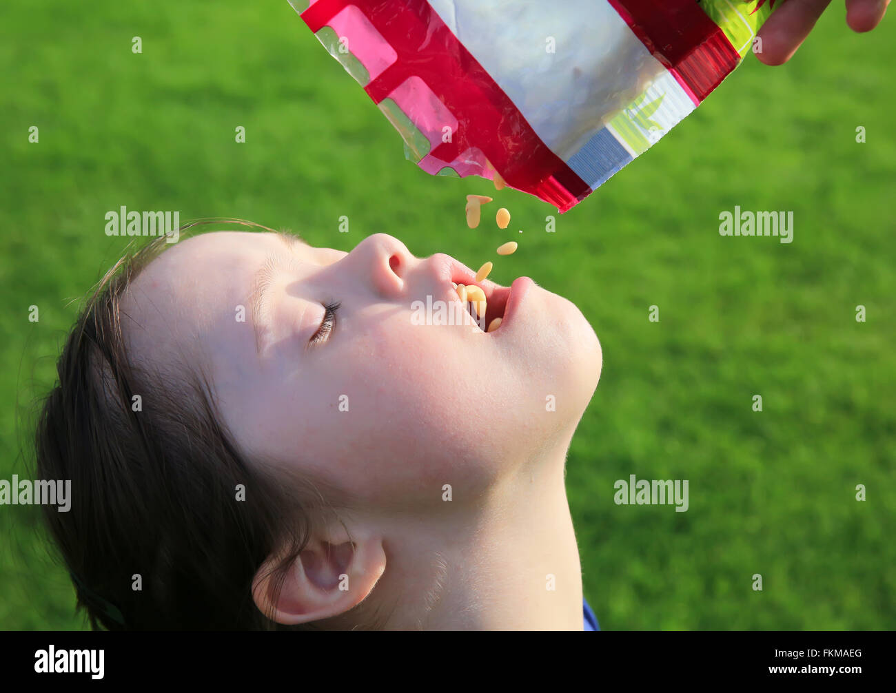 Little girl eating pine nuts Stock Photo - Alamy