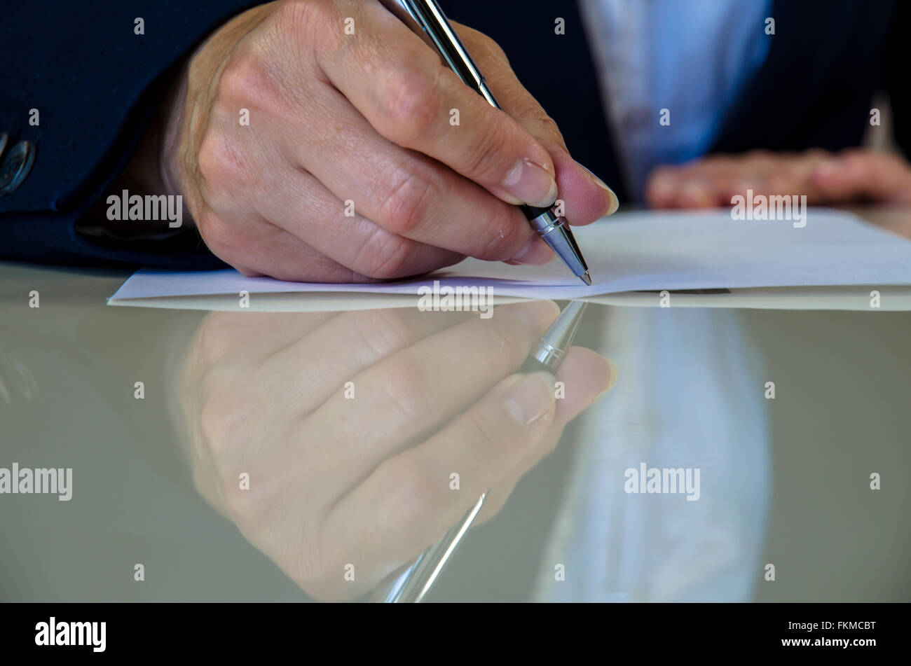 signing the paper with a pen Stock Photo - Alamy