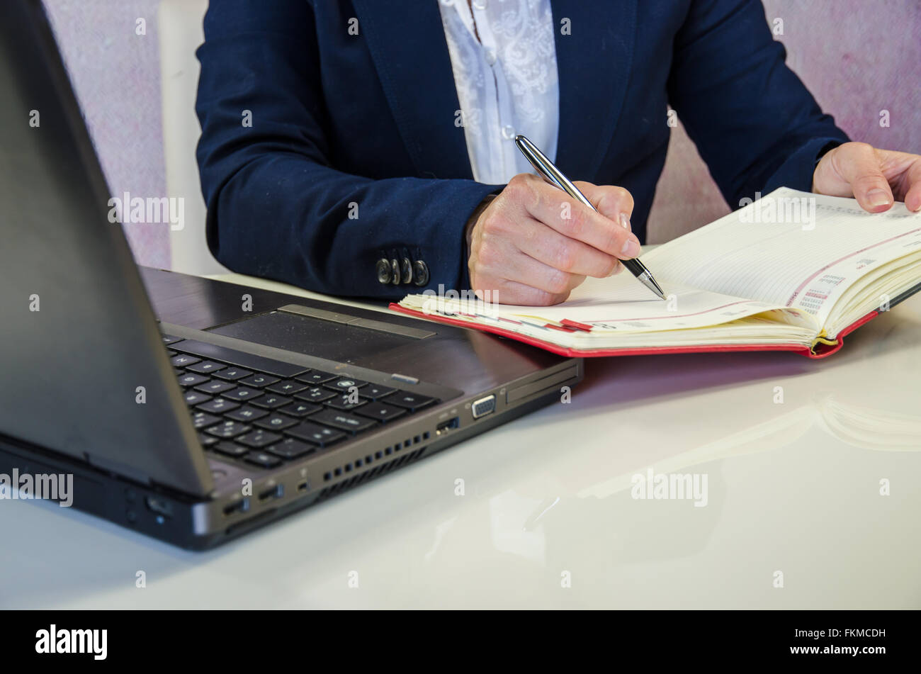 female hand writing with pen into notepad Stock Photo - Alamy