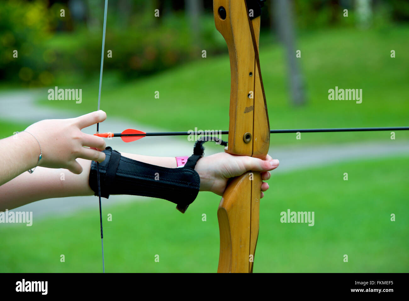 Archer about to shoot with bow and arrow Stock Photo - Alamy