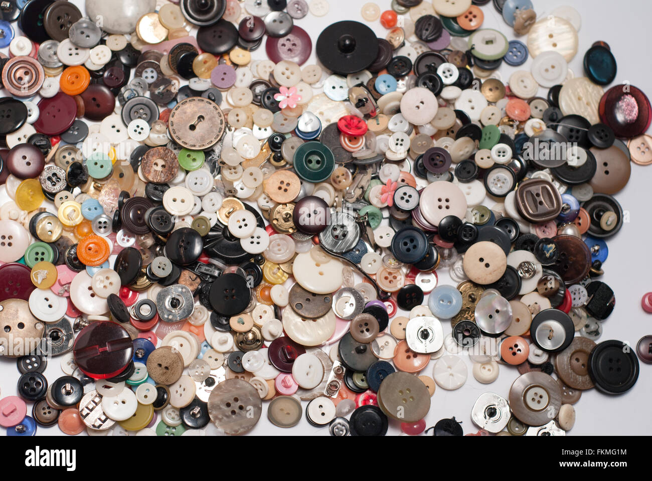 Lots of buttons scattered on the table Stock Photo - Alamy