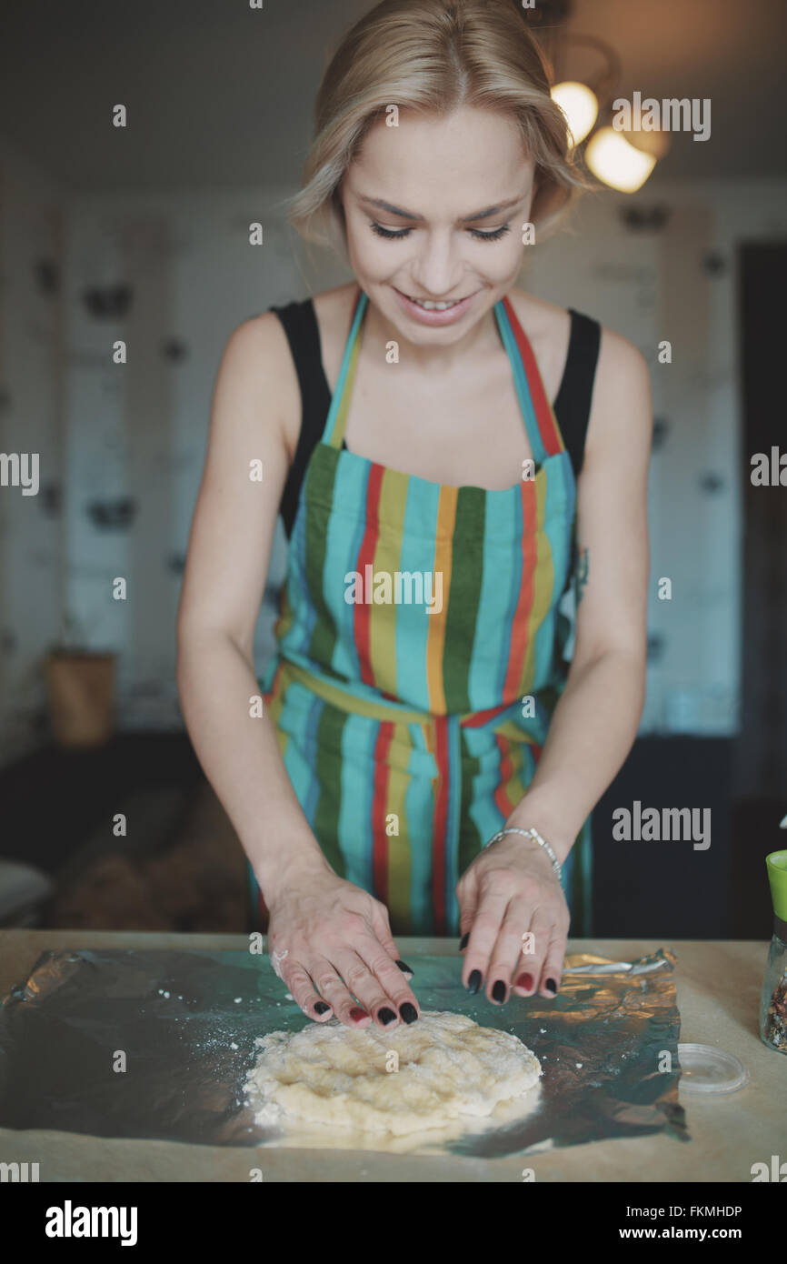 Woman cooking pizza at kitchen Stock Photo - Alamy