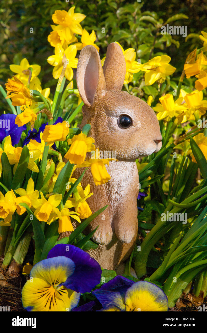 A Ceramic Rabbit placed amongst spring flowers Stock Photo - Alamy