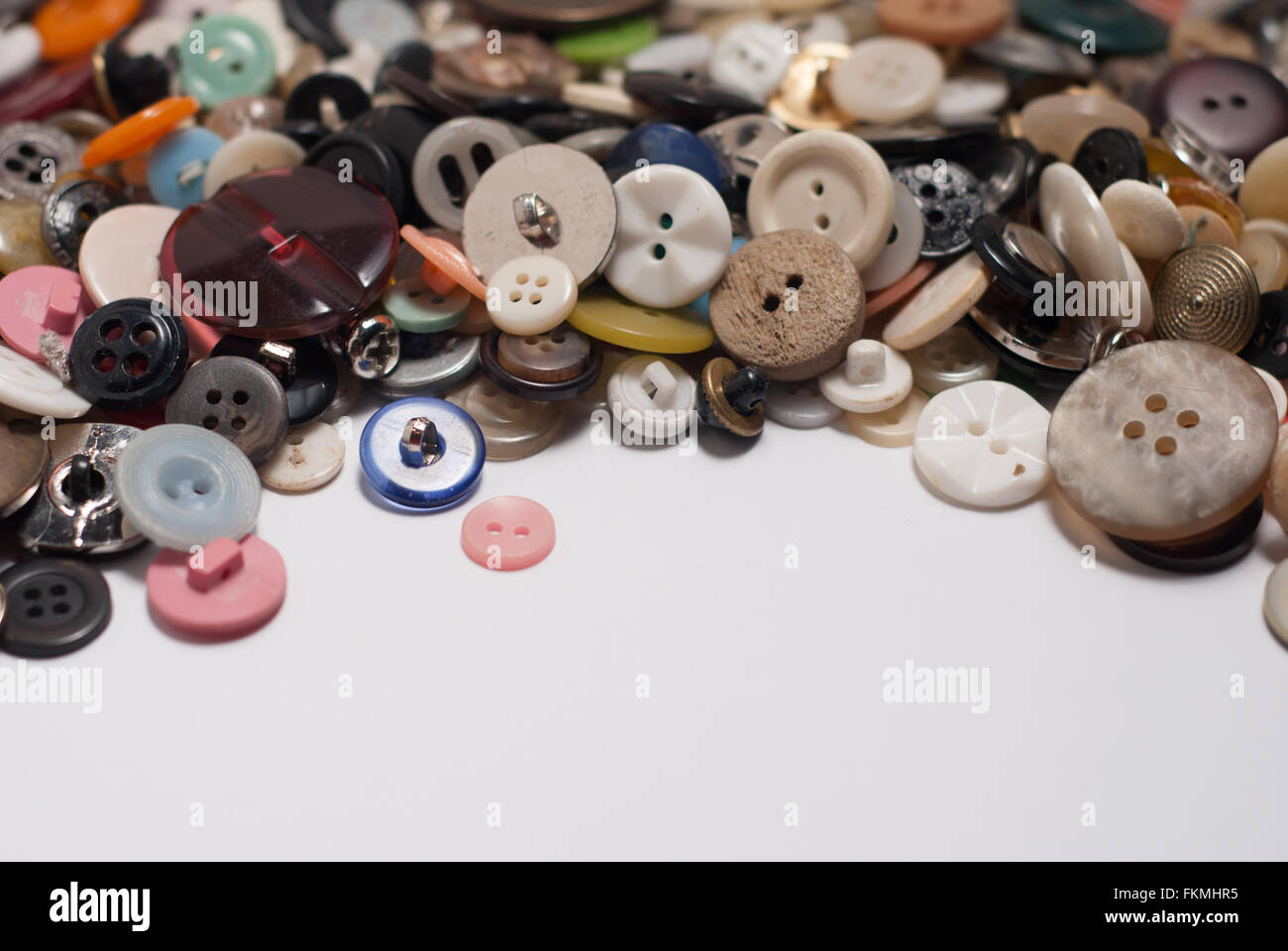set of different buttons. tablewith copy space. close up. white ...