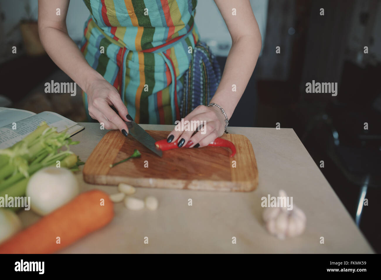 Young woman cutting vegetables Stock Photo - Alamy