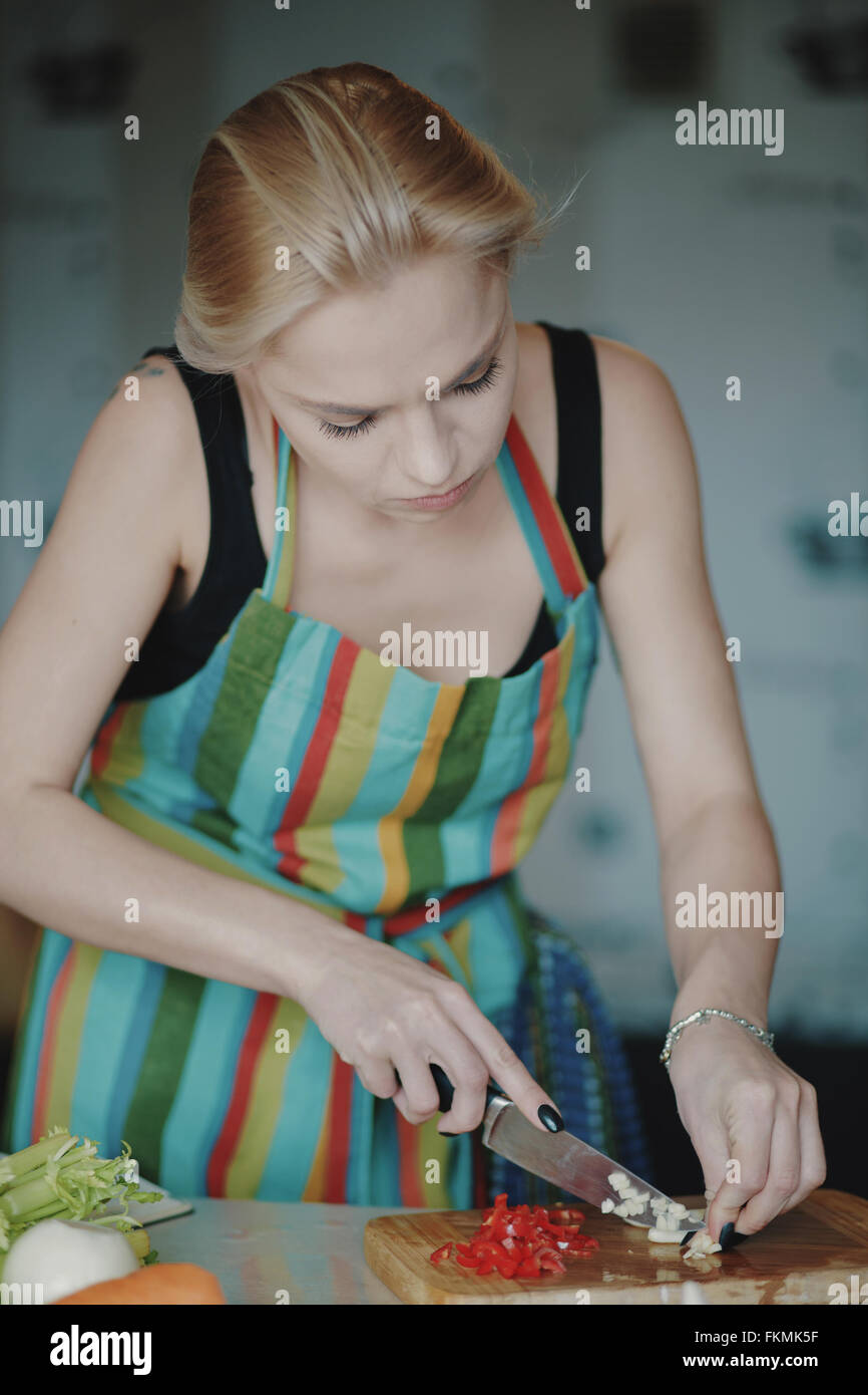 Young woman cutting vegetables Stock Photo - Alamy