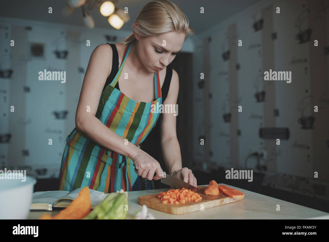 Young woman cutting vegetables Stock Photo - Alamy
