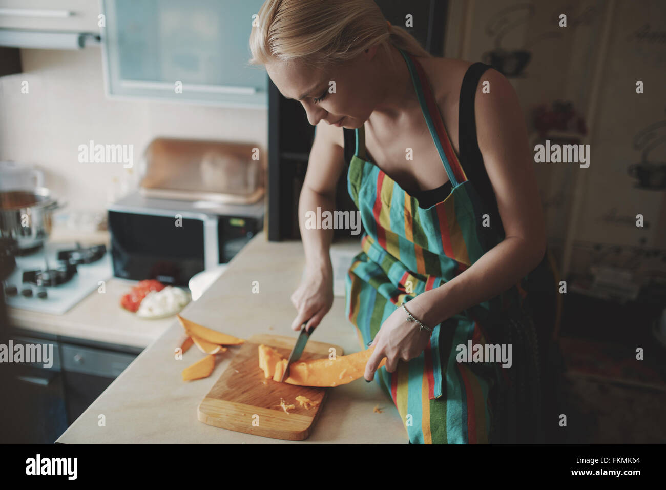 Young woman cutting vegetables Stock Photo - Alamy