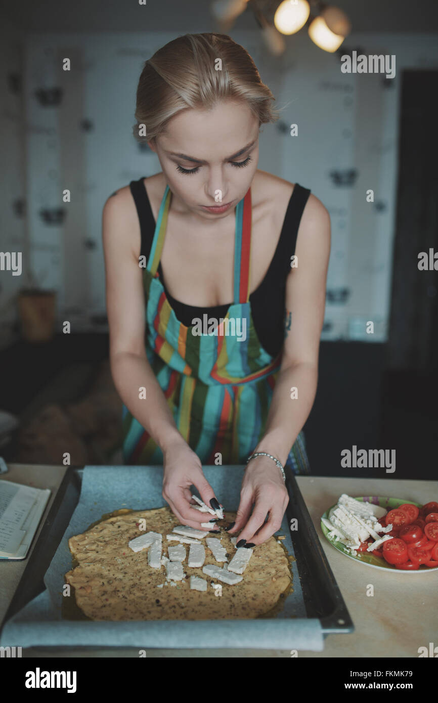 Woman cooking pizza at kitchen Stock Photo - Alamy