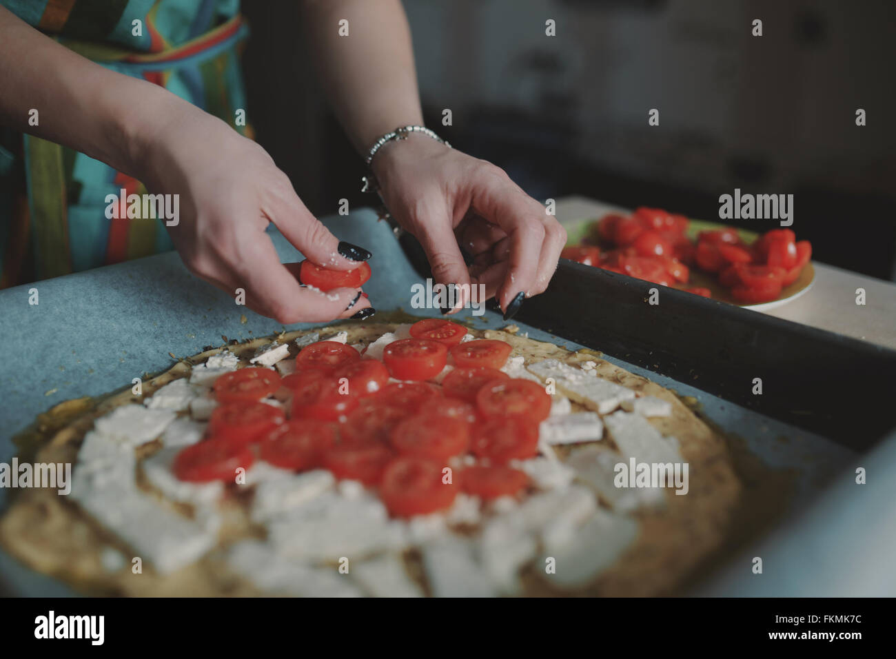 Woman cooking pizza at kitchen Stock Photo - Alamy