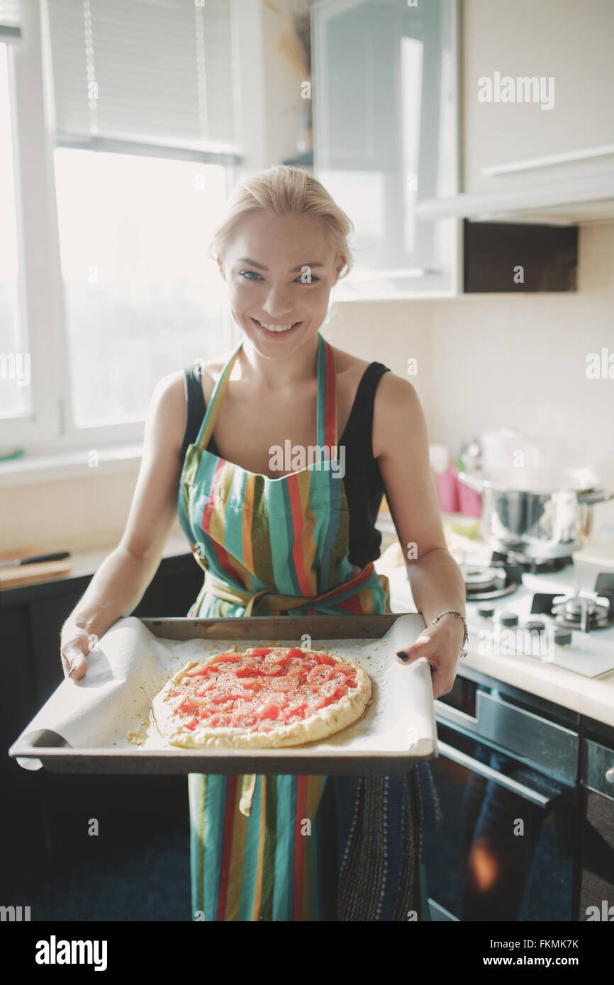 Woman cooking pizza at kitchen Stock Photo - Alamy