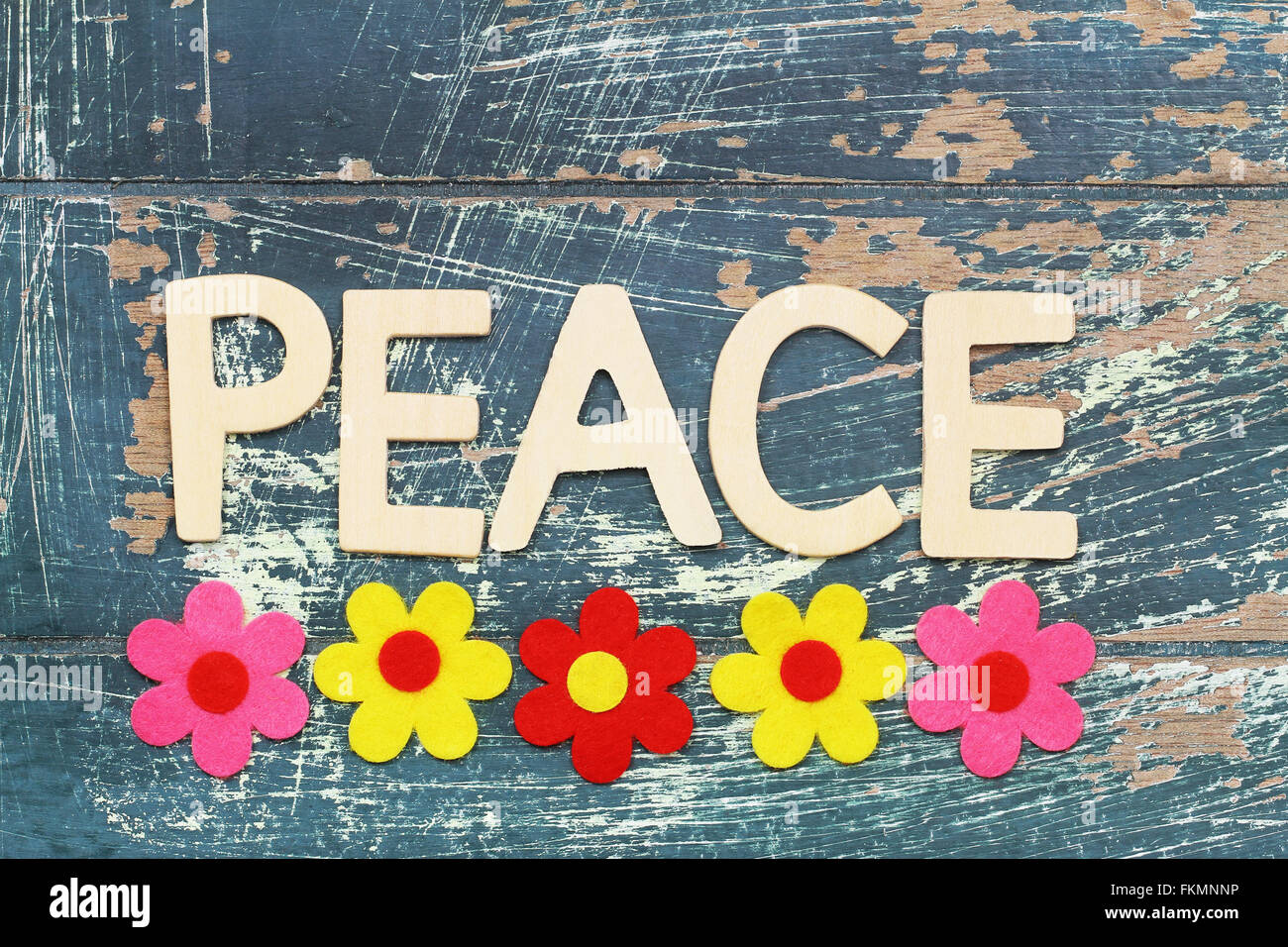 Peace written with wooden letters on rustic surface and colorful ...