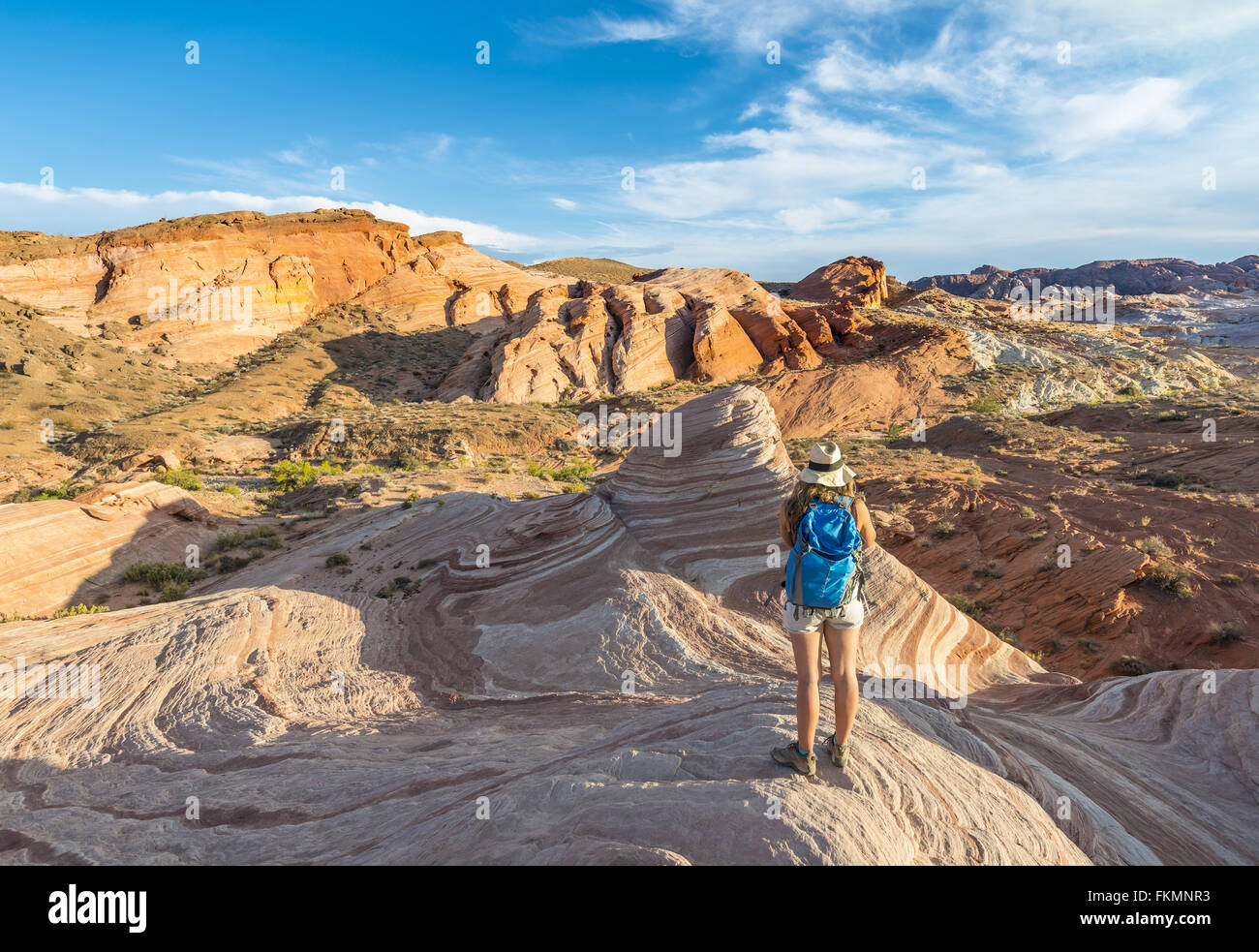 Tourist, hiker at the Fire Wave Sandstone Formation, behind Sleeping ...