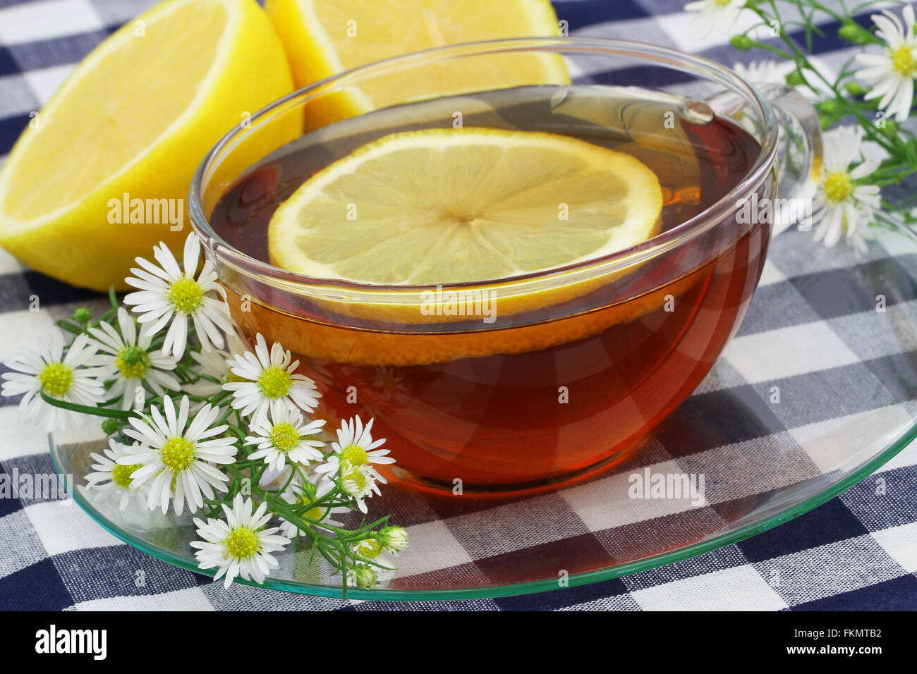 Cup of lemon tea with fresh chamomile flowers on the side Stock Photo ...