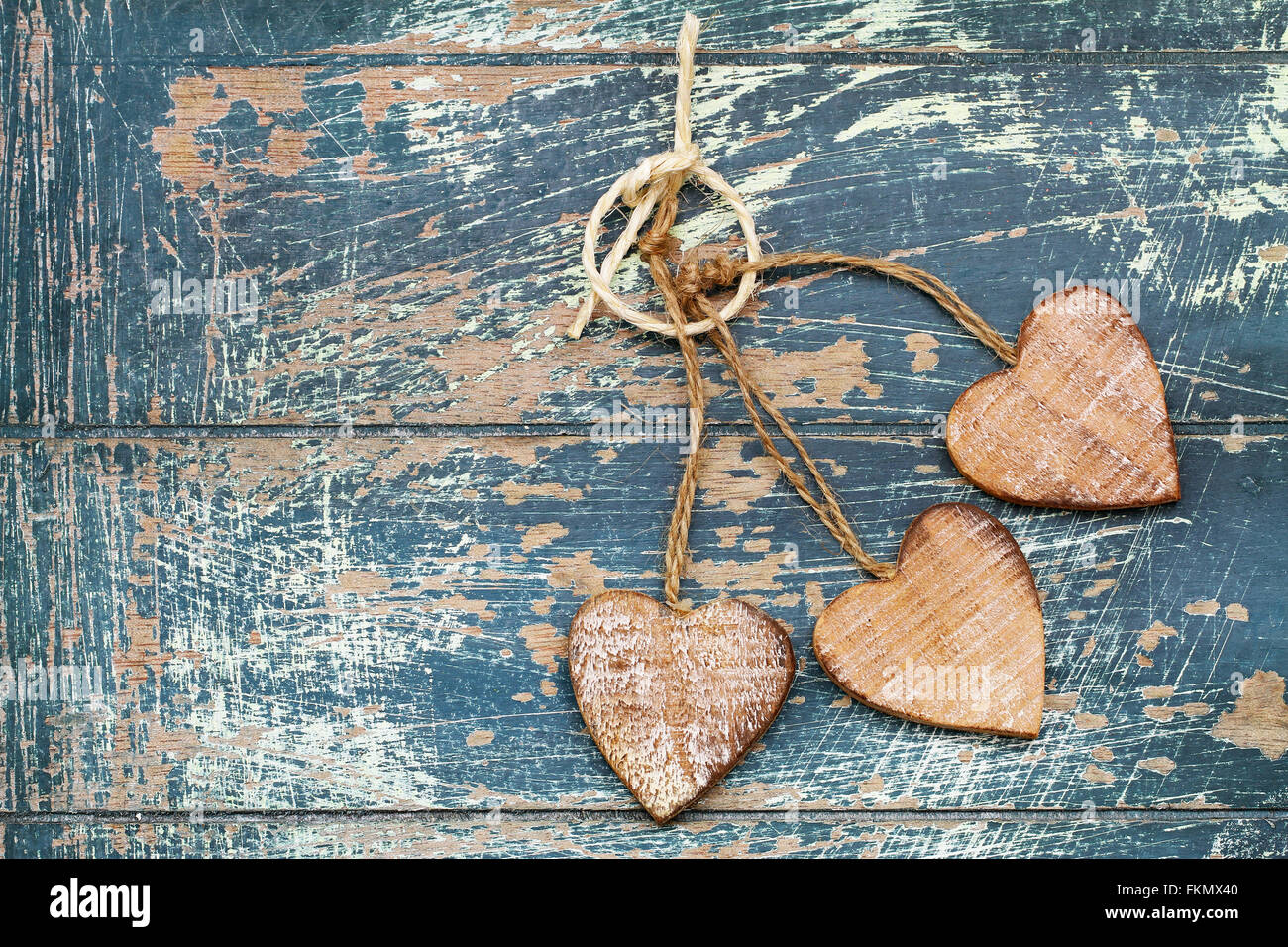 Three wooden hearts on rustic surface with copy space Stock Photo - Alamy