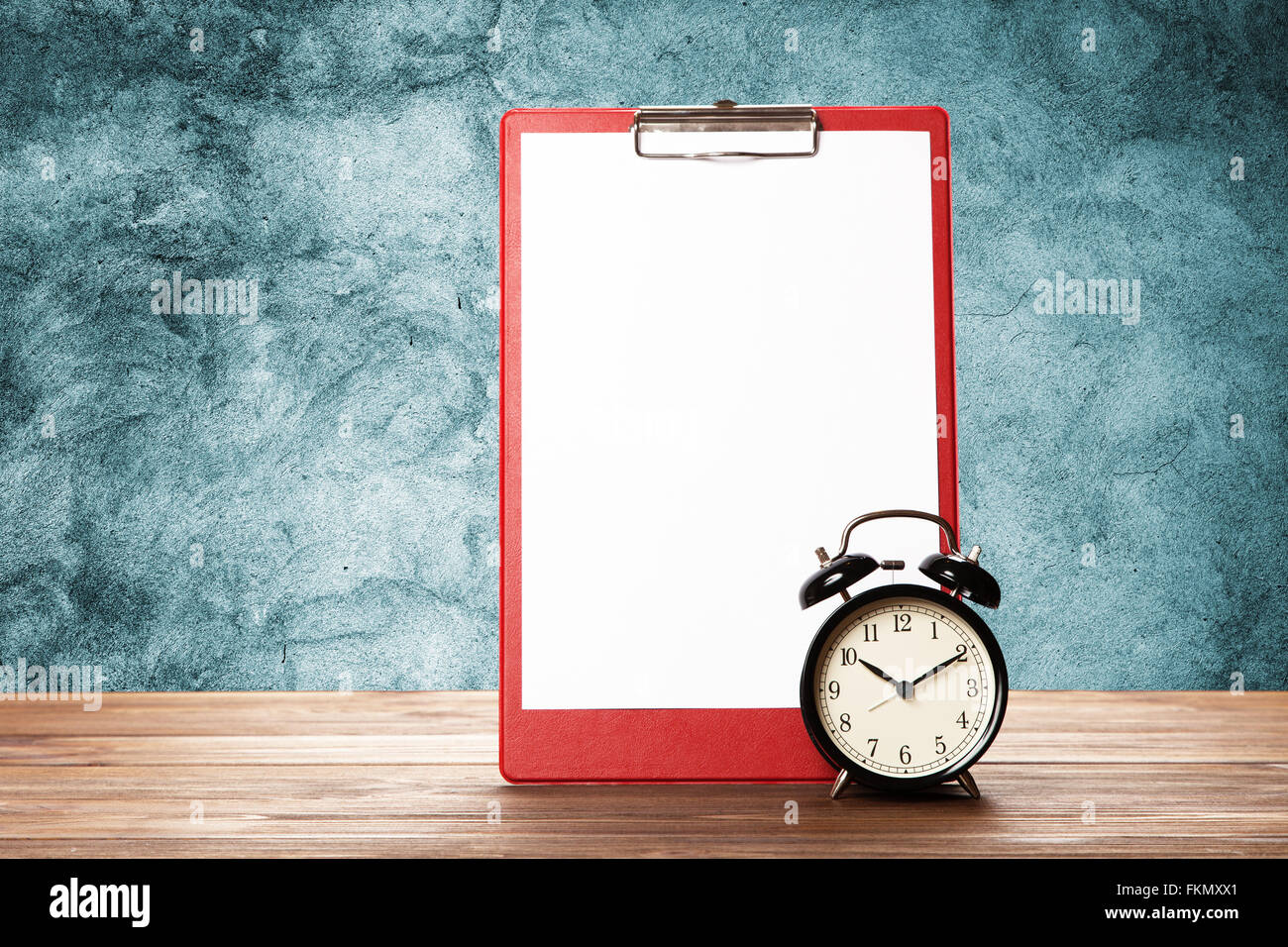 Blank paper sheet and alarm clock Stock Photo - Alamy