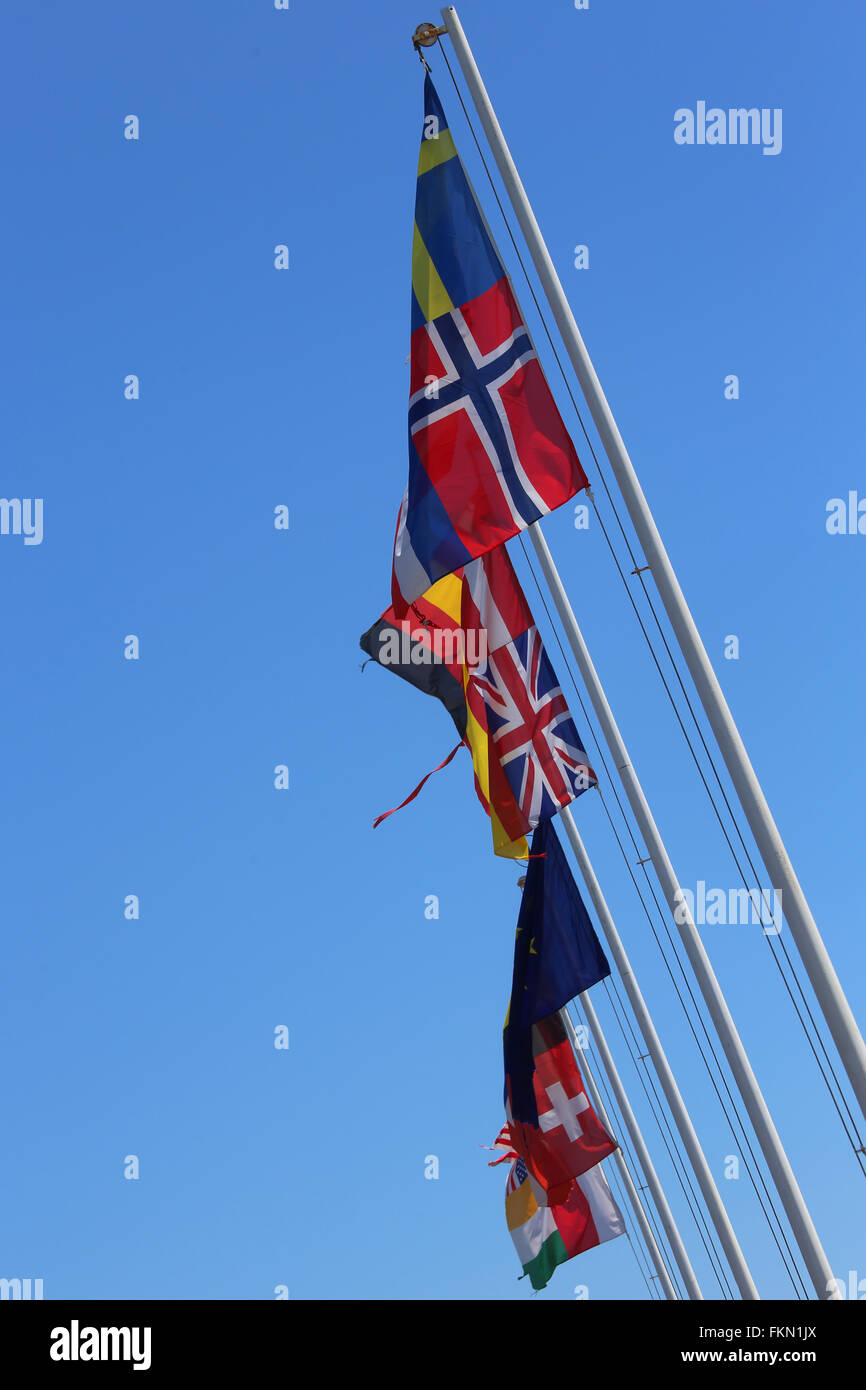 many flags of many nations world waving in the blue sky Stock Photo - Alamy