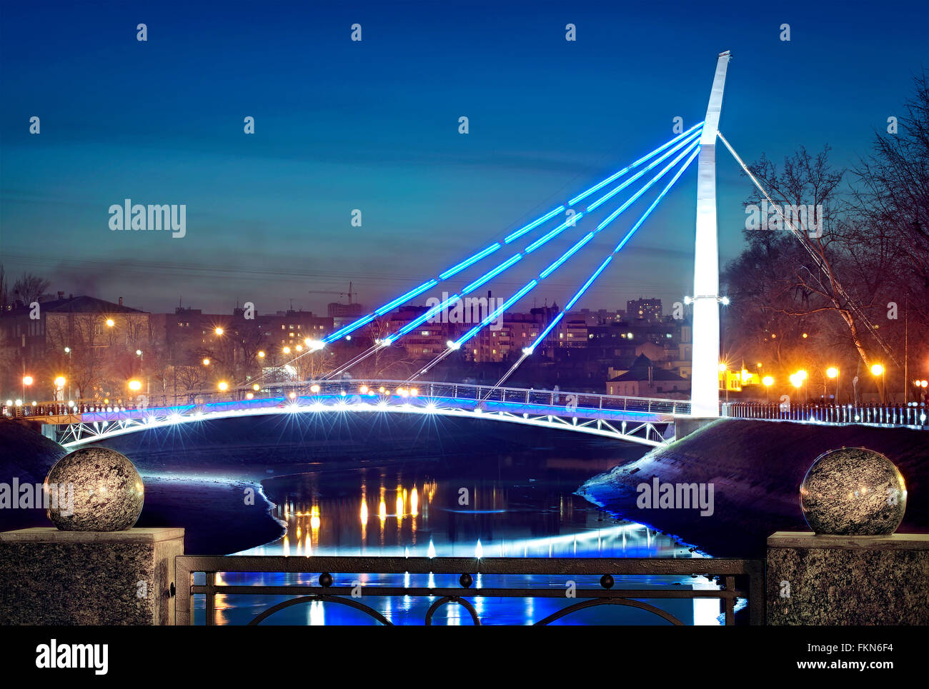 Illuminated bridge over the river on the waterfront Stock Photo - Alamy