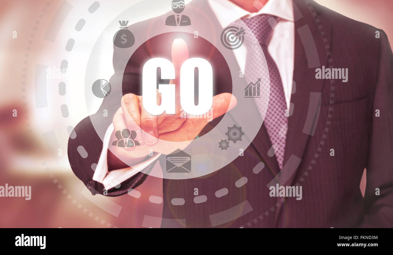 Businessman pressing a Go concept button Stock Photo - Alamy